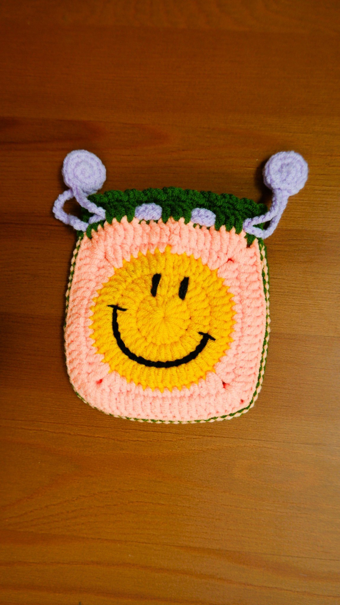 Smiley crochet pocket, yellow-orange
