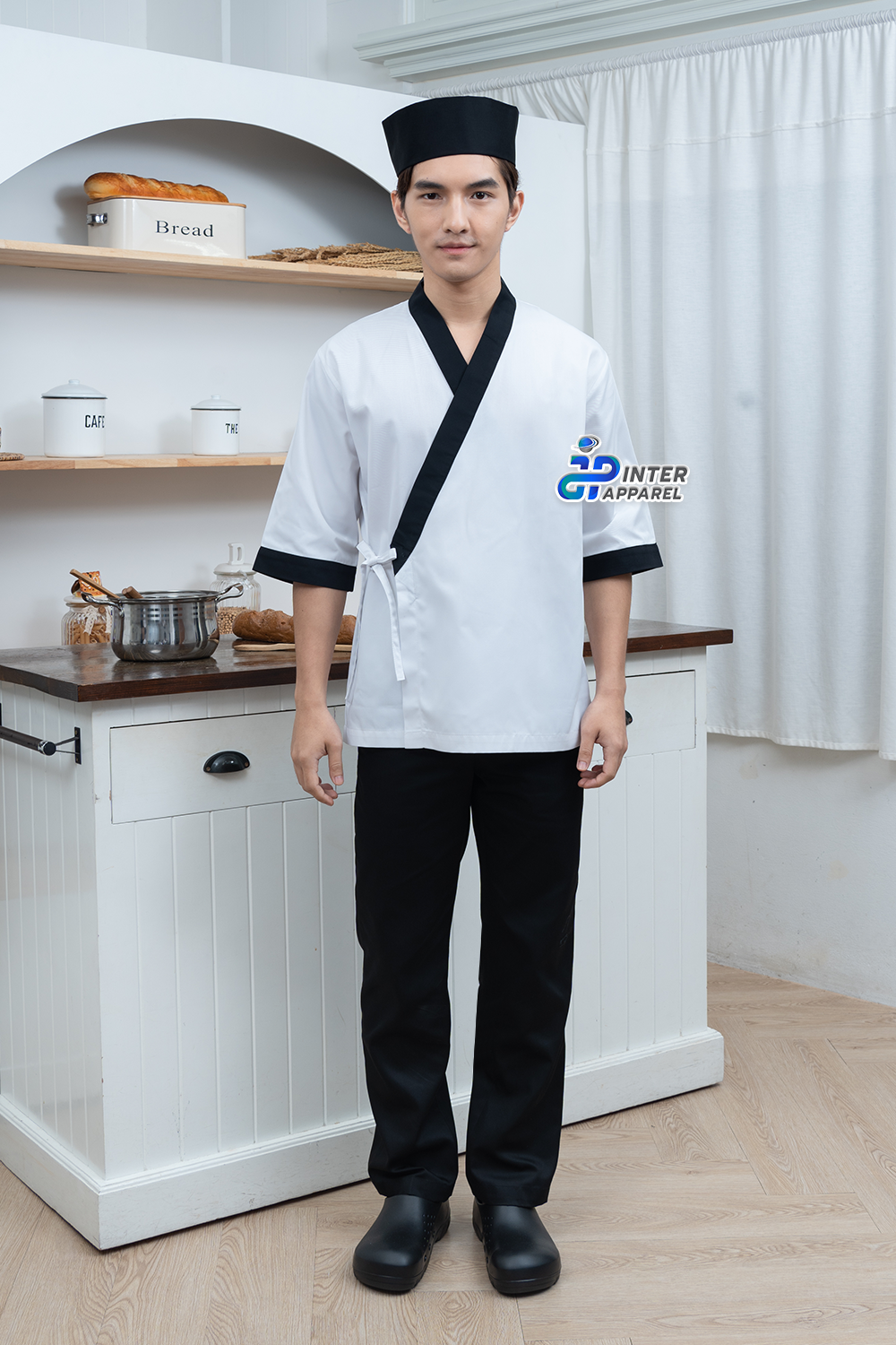 White Japanese chef coat with three-quarter sleeves and black piping.